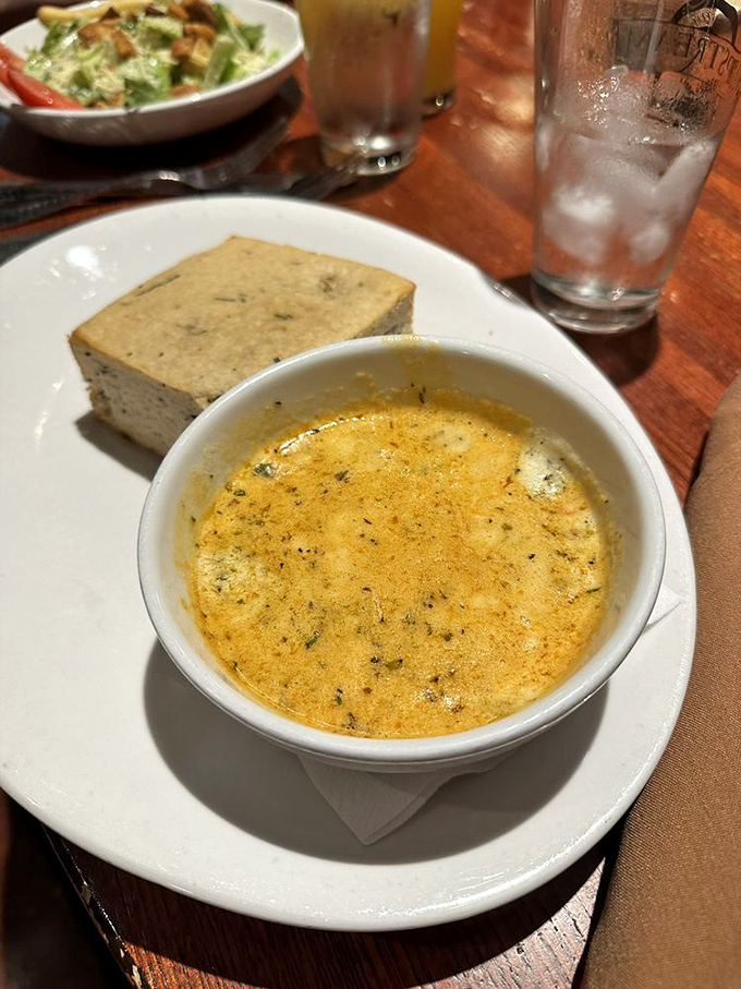 A bowl of sunshine disguised as soup, served with cornbread that would make your grandmother nod in approval.