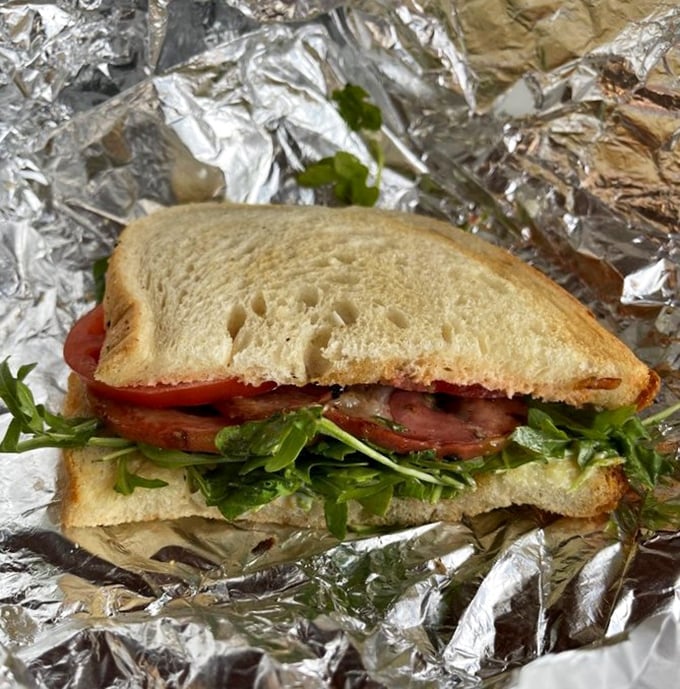 Fresh arugula and tomato bring brightness to this simple sandwich, proving that sometimes the most straightforward pleasures deliver the most profound satisfaction.