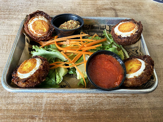 Scotch eggs: where breakfast meets bar food in a crispy-coated romance that would make Shakespeare write sonnets about yolk porn.