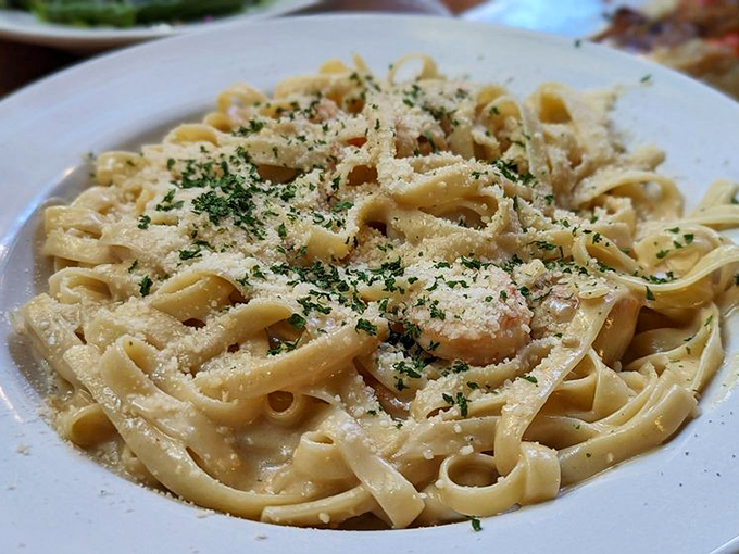 Fettuccine Alfredo that doesn't whisper but announces its creaminess with authority. Parmesan-dusted pasta that's worth every carbohydrate.