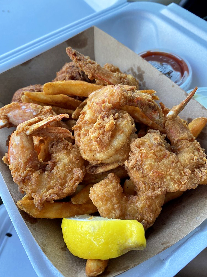 Golden-fried shrimp that snap between your teeth, paired with fries that could make a potato proud. The lemon wedge isn't decoration&mdash;it's essential equipment. 