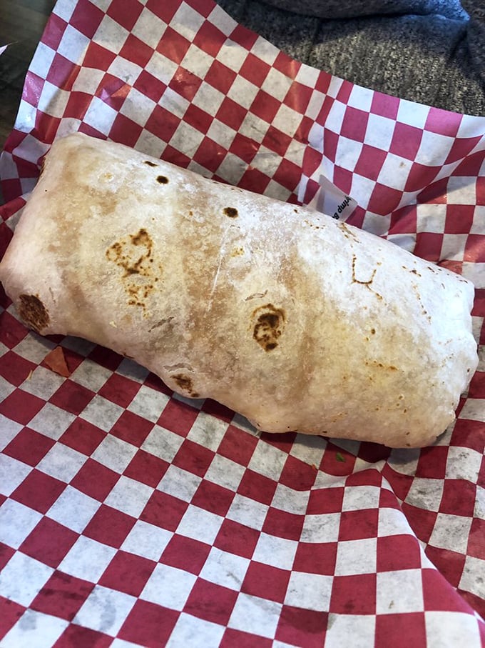 Cross-section perfection: tender steak, seasoned rice, and fresh veggies wrapped in a warm tortilla. It's architectural genius you can eat with your hands.
