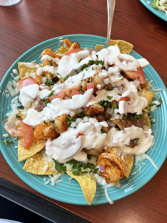 Shrimp nachos that would make coastal Mexico proud, with each succulent piece nestled among chips like hidden treasure waiting to be discovered.