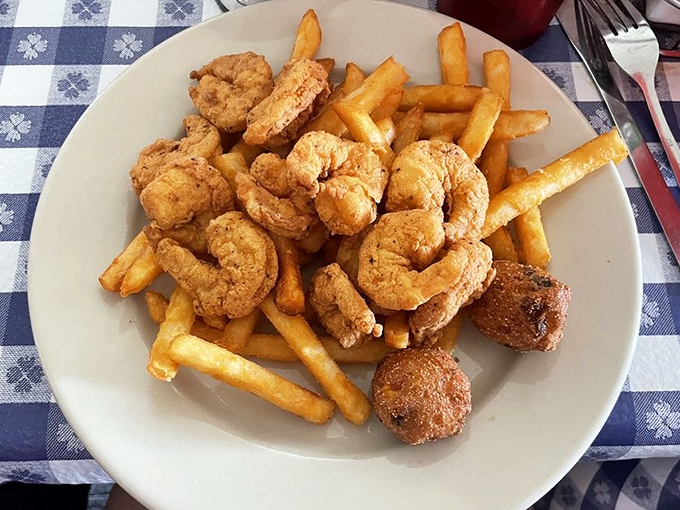 Gulf shrimp fried to golden perfection alongside crispy fries and hushpuppies &ndash; the holy trinity of Louisiana comfort food.