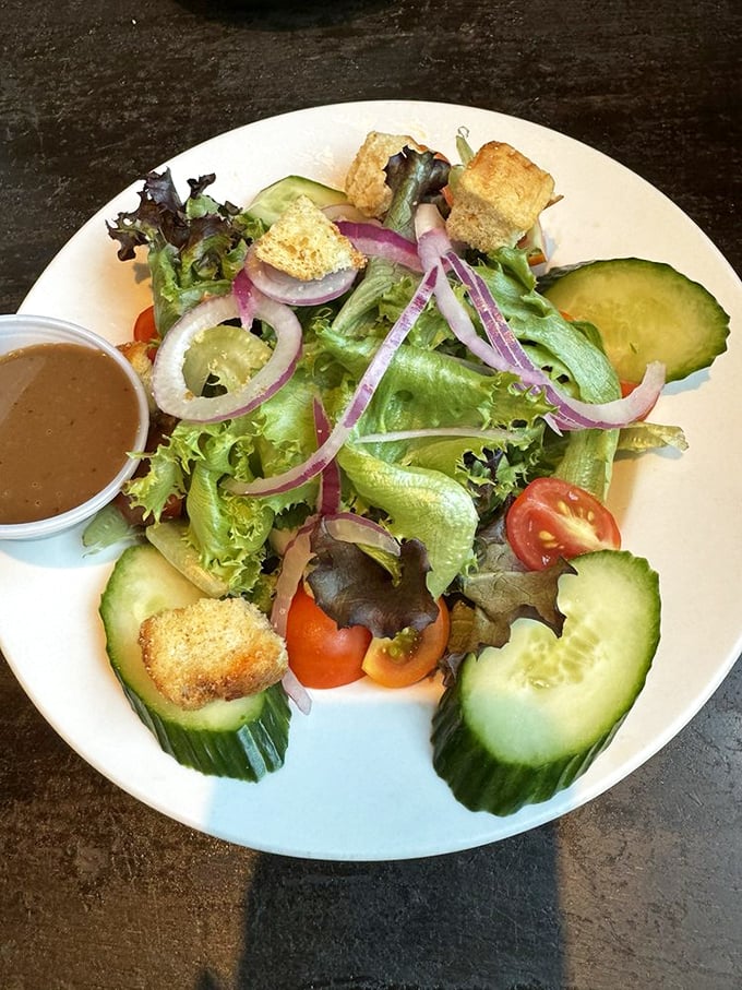 A house salad that defies the "rabbit food" stereotype &ndash; crisp, colorful, and composed with enough care to make you temporarily forget about the fish and chips.