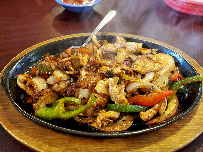 Sizzling fajitas announce themselves before they're even visible. This aromatic medley of chicken, peppers, and onions performs a tableside concert.