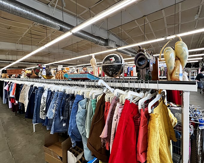 A rainbow of fabrics tells the story of fashion through the decades. Each hanger holds not just clothing, but potential new beginnings.
