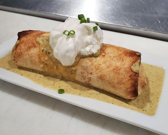 Not all burritos wear sombreros. This jerk chicken creation, topped with cool sour cream, brings Caribbean flair to Mexican tradition.