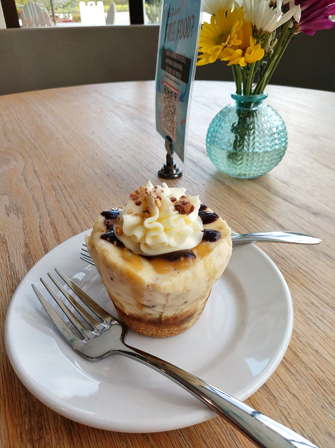 Caramel drizzle performing a gravity-defying dance on whipped cream—this cheesecake doesn't just satisfy cravings, it creates new ones.