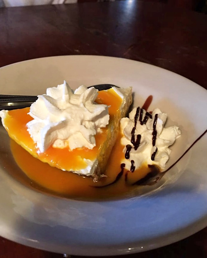 Sour Orange Pie: Florida's tangy answer to Key Lime. This sunset-colored slice comes with whipped cream clouds and chocolate rain.