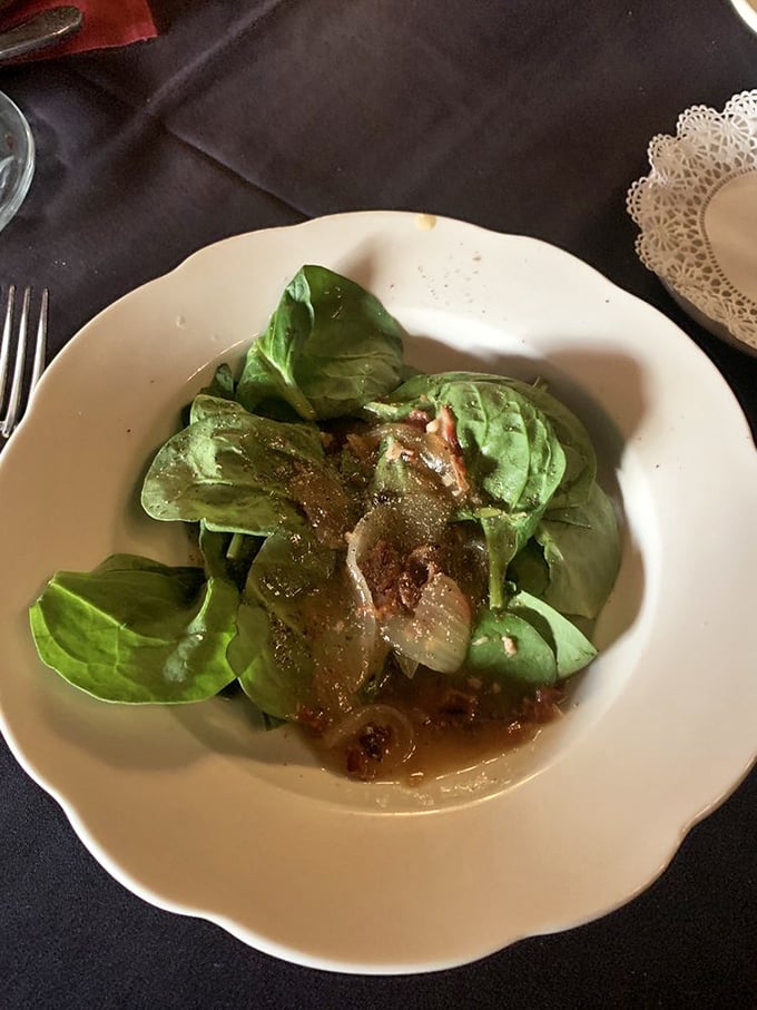 A spinach salad that proves vegetables can be both virtuous and delicious. The warm bacon dressing transforms simple leaves into something sublime.