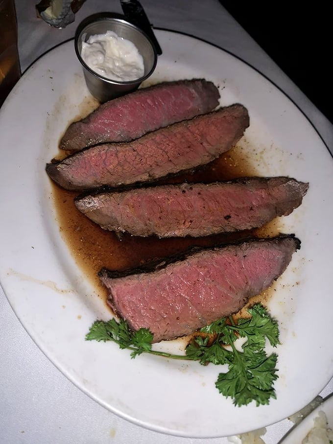 Sliced with surgical precision, this medium-rare masterpiece tells the story of proper aging and cooking technique with each rosy, juice-laden bite.