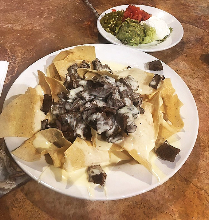 Steak nachos with the works&mdash;a plate that answers the eternal question: "Can happiness be served with guacamole on the side?" (Spoiler: yes, it can.)