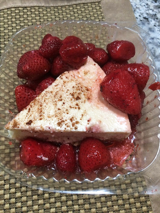 Fresh strawberries surround cheesecake like adoring fans at a concert, each bite a perfect harmony of creamy and tart.