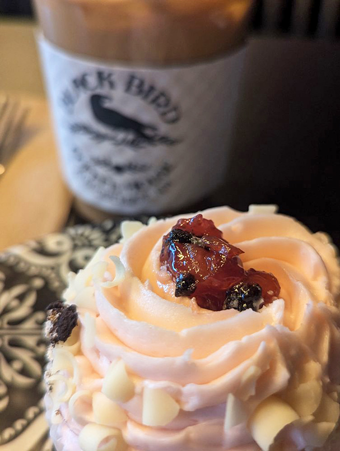 Cupcake architecture at its finest. This strawberry masterpiece with its swirled frosting peaks and berry garnish isn't just dessert&mdash;it's edible art with a coffee chaser.