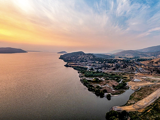 Upper Klamath Lake transforms into liquid gold at sunset, with the city's silhouette creating a perfect backdrop for nature's nightly masterpiece.