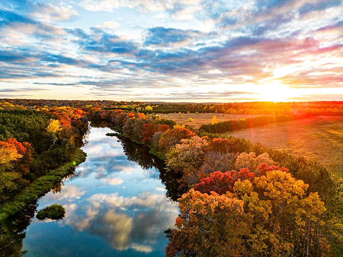 The Baraboo River in autumn glory proves Mother Nature is the ultimate Instagram influencer. No filter needed when reality looks this good.