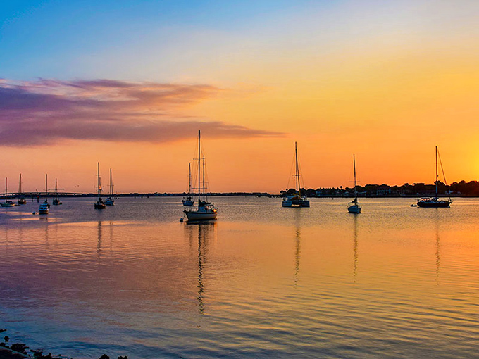 Golden hour transforms Matanzas Bay into a dream, where sailboats become silhouettes against a sky that looks like nature's greatest watercolor experiment.