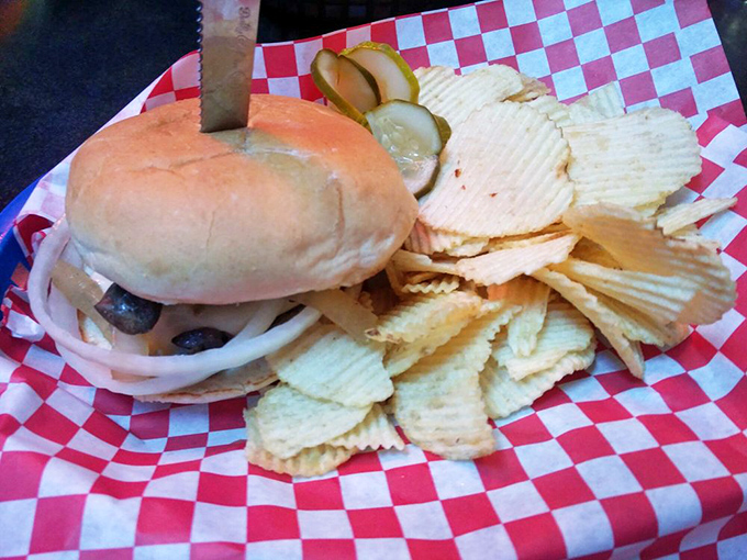 Simplicity perfected: A classic burger with crisp pickles and chips. Sometimes the straightforward approach hits all the right notes.