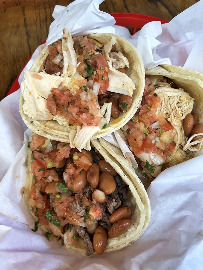 Taco perfection in its natural habitat. The simplicity of meat, onions, and cilantro on corn tortillas is the culinary equivalent of a perfect power chord.