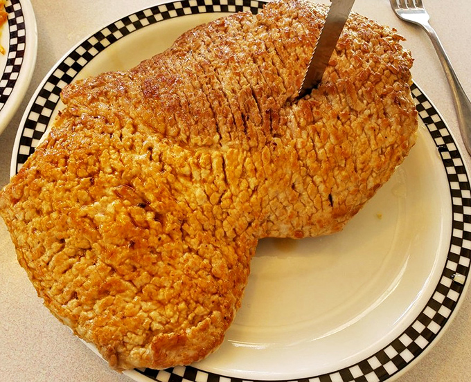 Indiana's iconic breaded tenderloin in all its golden glory. When your meat eclipses your plate, you know you're in the right place.