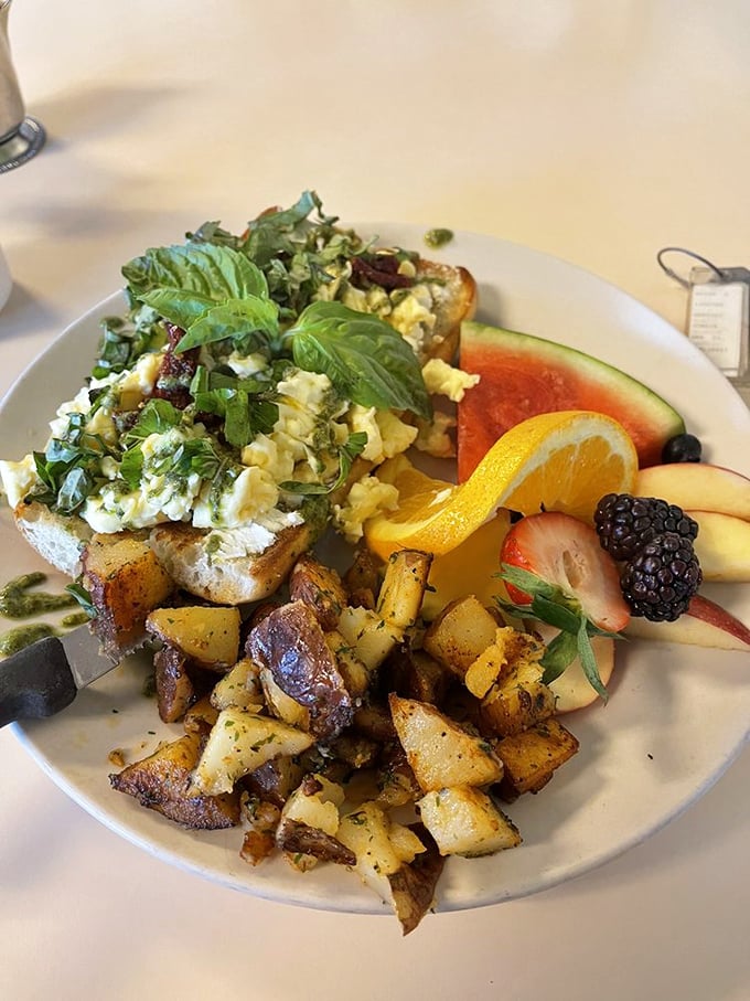 Breakfast artistry at its finest&mdash;eggs, fresh herbs, and perfectly roasted potatoes sharing space with fruit that looks hand-selected by Mother Nature herself.