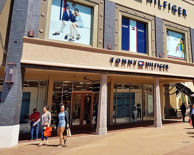 Tommy Hilfiger's classic American style beckons from behind pristine glass, promising preppy perfection at prices that won't sink your yacht.