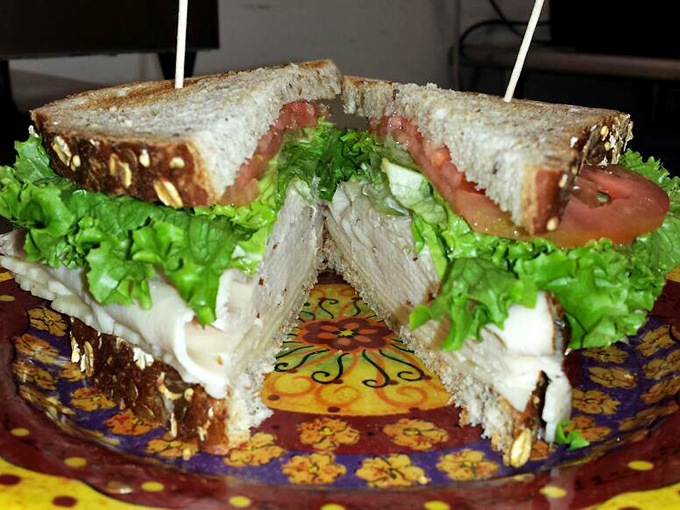 A sandwich so fresh and vibrant it could qualify for its own wellness influencer account, with crisp greens and tender meat nestled between bread that knows its purpose.