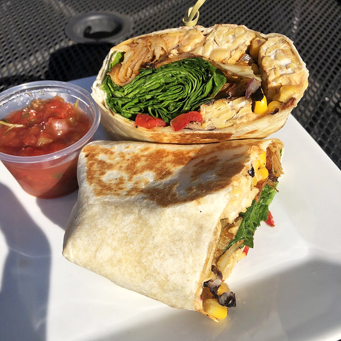 The vegan breakfast burrito proves plant-based can be decadent too, with fresh greens peeking out like they're waving "eat me first!"
