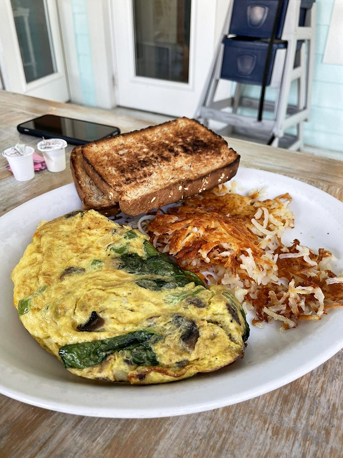 An omelet should be a canvas for vegetables, not just their hiding place. This one proudly displays its garden-fresh contents like medals of honor. 