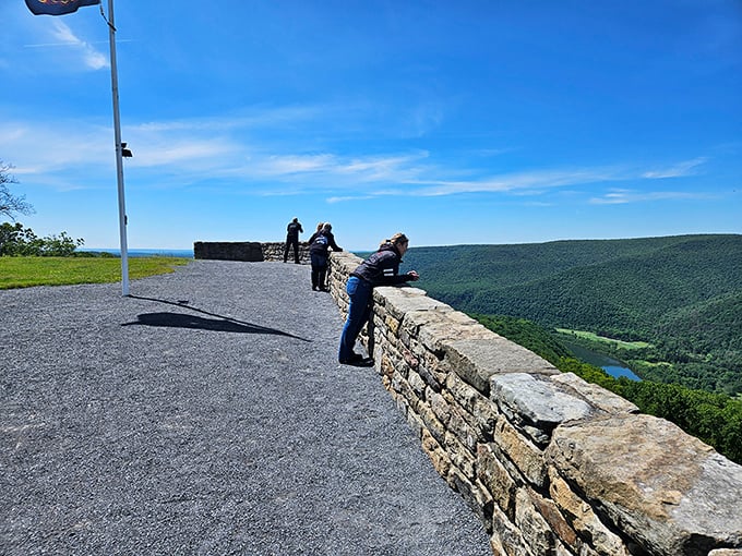 Stone wall philosophers. These visitors lean into contemplation at 1,300 feet, where the air is fresher and thoughts somehow clearer.