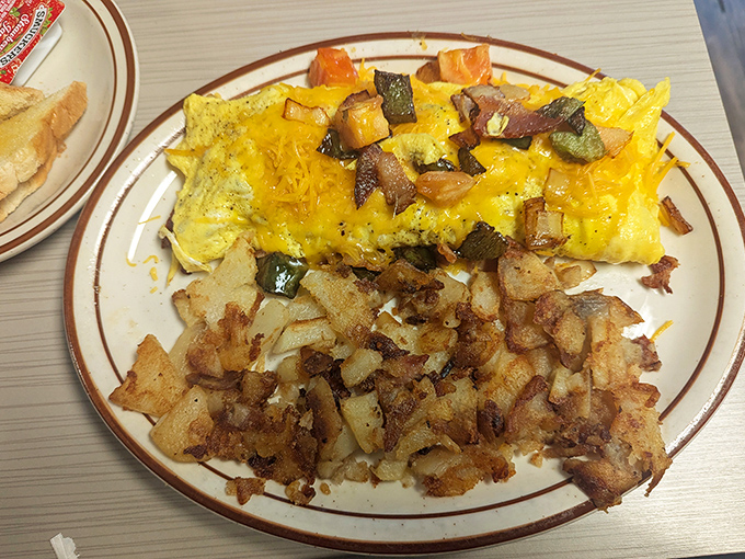The Western omelet&mdash;where vegetables pretend they're attending a cheese party. Those home fries are the crispy supporting actors who steal the scene.