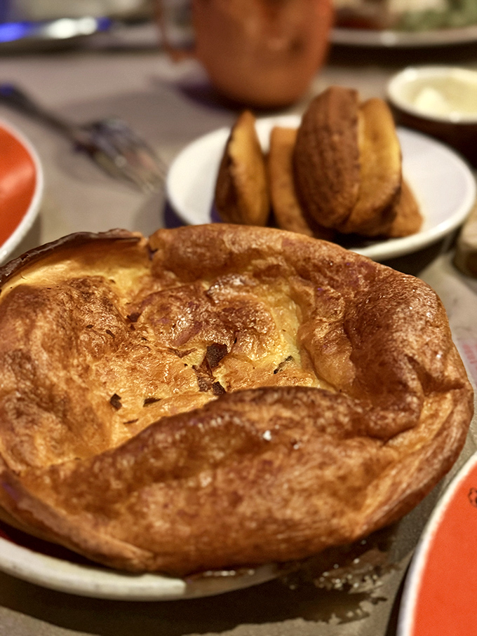 The Yorkshire pudding rises to the occasion, creating the perfect vehicle for soaking up those precious meat juices like nature's most elegant sponge.