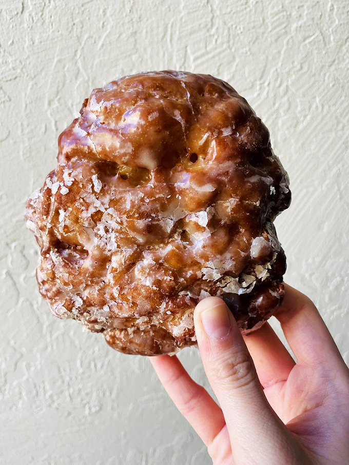 This apple fritter isn't just a donut &ndash; it's a craggy, caramelized mountain range of sweet satisfaction dusted with crystal sugar snow.