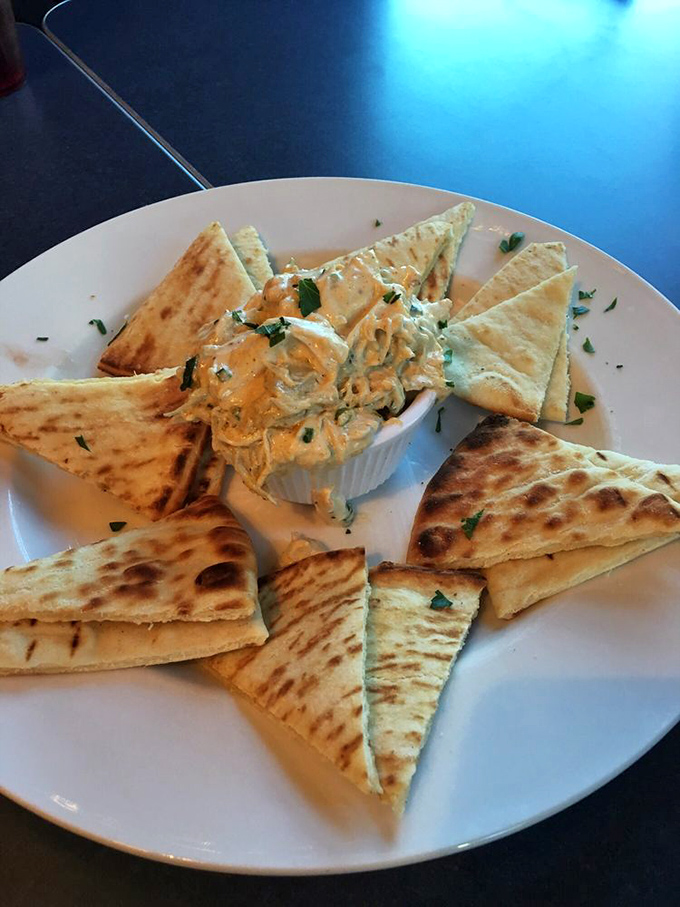 Triangles of warm pita surround a creamy dip like devoted fans at a concert&mdash;simple geometry never tasted so good.