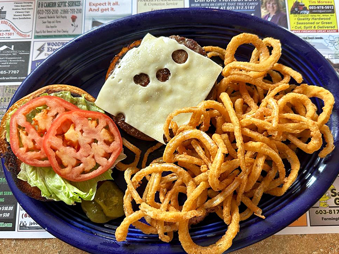 This burger isn't trying to win Instagram fame—it's just quietly being delicious with melty cheese, crisp veggies, and those golden onion rings stealing the spotlight.