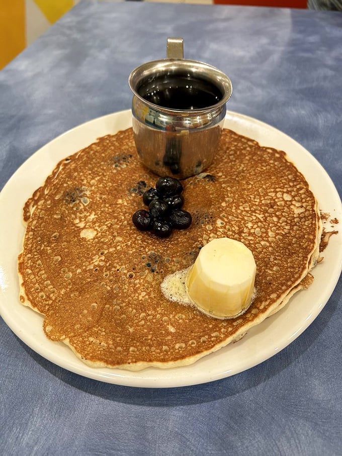 The pancake that launched a thousand return visits. Thin, crispy-edged, and topped with blueberries and butter&mdash;breakfast nirvana achieved.