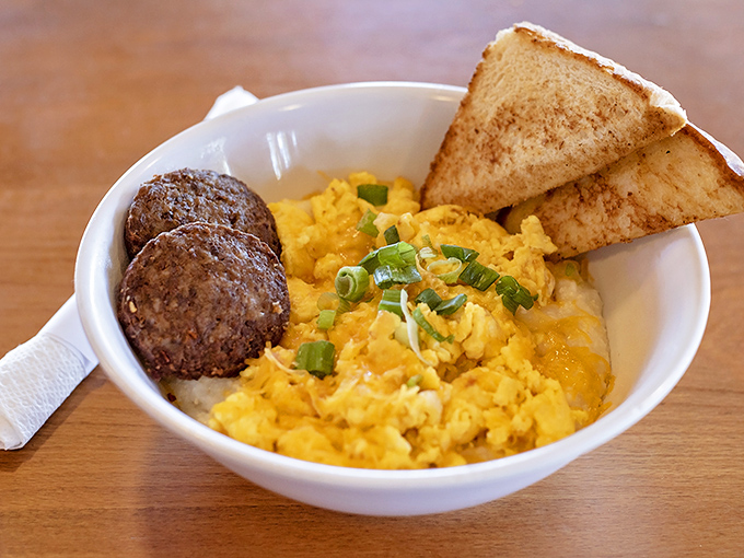 Sunshine in a bowl &ndash; creamy grits topped with eggs and savory sausage. Southern comfort that speaks a universal language.