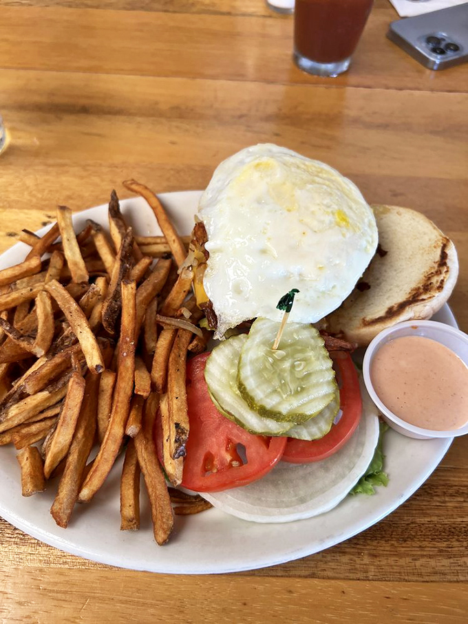 Breakfast burger nirvana! The runny egg creates nature's perfect sauce, while those house-cut fries deserve their own fan club.