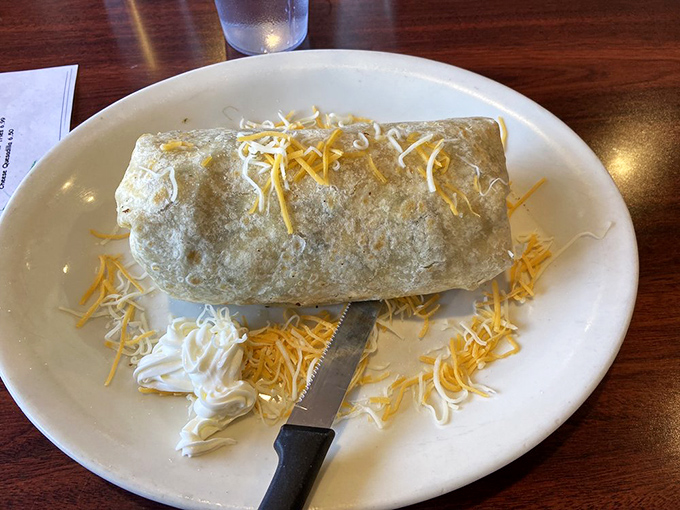 This breakfast burrito isn't just a meal—it's a commitment. Cheese-topped tortilla perfection that could fuel you through a marathon.