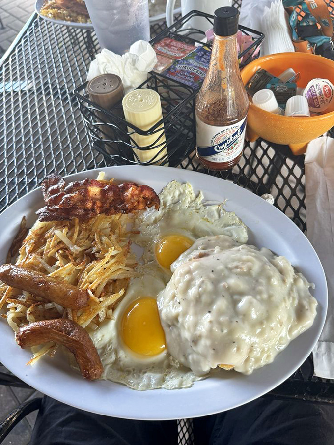 Breakfast perfection: crispy bacon, sunny-side-up eggs, and hash browns that somehow manage to be both crispy and tender in all the right places.