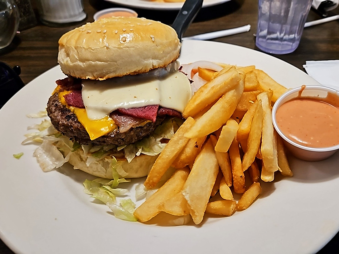 This isn't just a burger; it's a towering monument to lunch aspirations with cheese cascading down the sides like delicious lava.