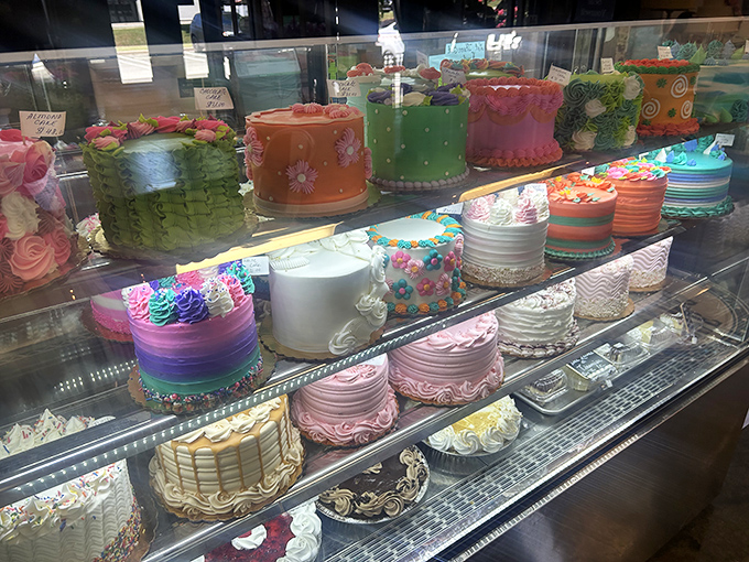 A rainbow of celebration cakes standing at attention, ready to turn ordinary Tuesdays into memorable occasions with just one slice.