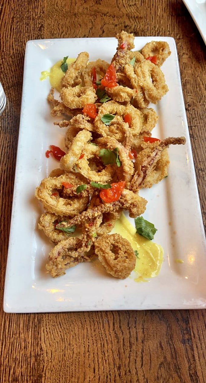 Calamari that defies the rubbery reputation of lesser versions &ndash; light, crisp, and brightened with sweet peppers and fresh herbs. No marinara monotony here.