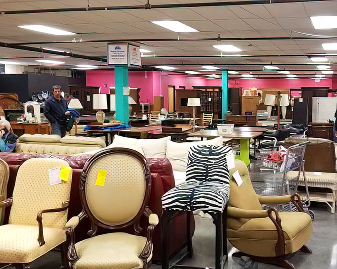 A furniture forest where sofas and armchairs gather like old friends at a reunion, each with character lines earned through years of loyal service.