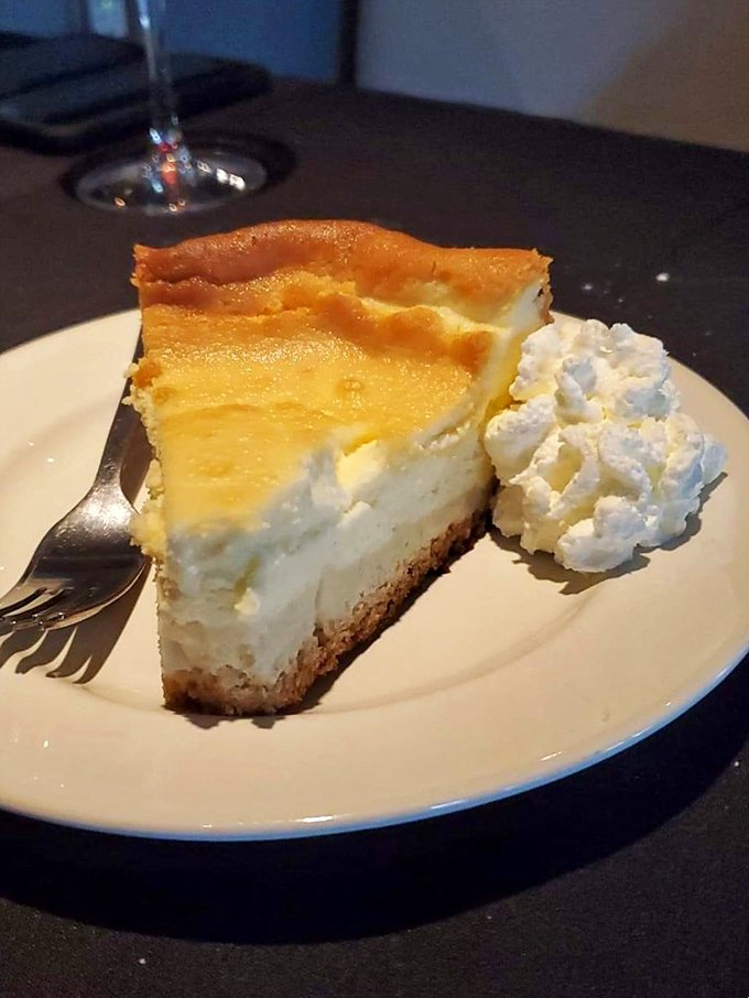 Cheesecake so heavenly it deserves its own halo. That cloud of whipped cream isn't garnish—it's the dessert equivalent of a perfect pillow after a magnificent meal.