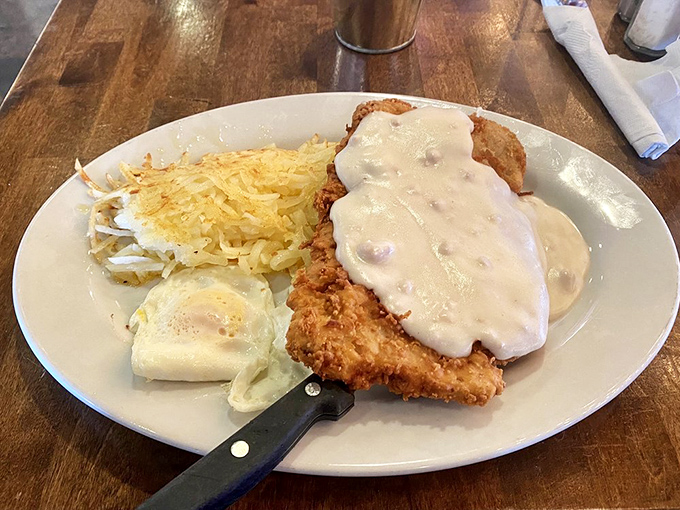 Chicken fried steak smothered in gravy so good you'll want to write poetry about it, paired with hashbrowns that achieve the perfect crisp-to-tender ratio.
