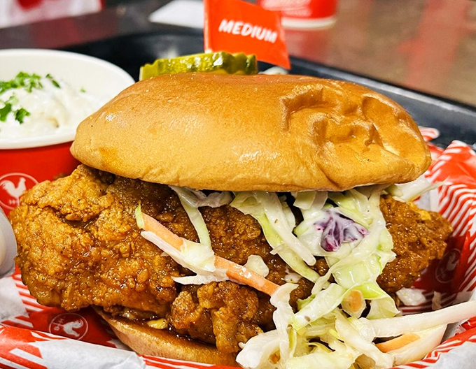 This chicken sandwich isn't just a meal, it's an event. The medium heat flag stands as both warning and invitation to flavor country.