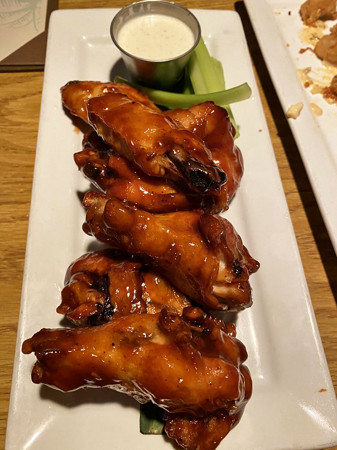 These glazed chicken wings glisten with sauce that could make vegetarians reconsider their life choices entirely.