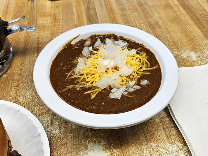 Chili that doesn't need a fancy pedigree to prove its worth—just shredded cheese slowly melting into that rich, beefy pool.